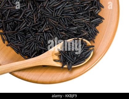 grains of black rice on wooden background Stock Photo - Alamy