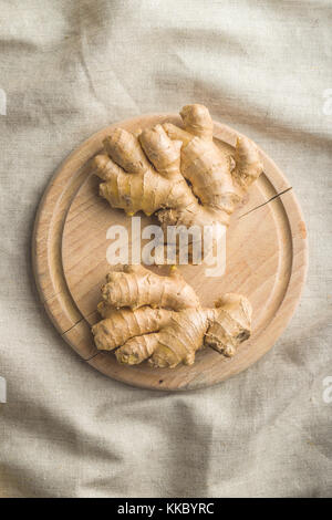Fresh ginger root on cutting board with sliced ginger on wooden ...