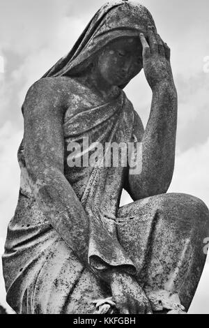 Tomb with kneeling female statue in bronze Stock Photo - Alamy