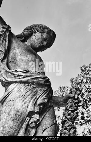 Man standing over grave at cemetery Stock Photo - Alamy