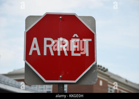 Stop sign (arret) in French and a pedestrian and bicycle sign near a ...