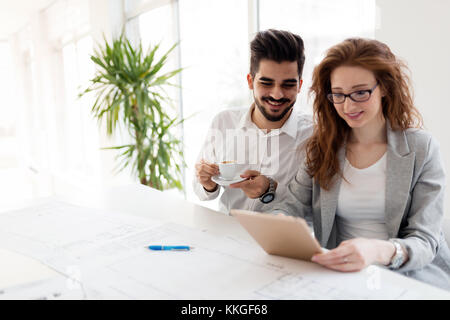 Architects, building engineers or designers with tablet talking ...