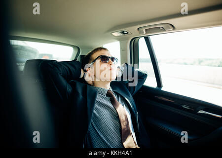 vehicle running self driving mode and a man driver being relaxed Stock ...