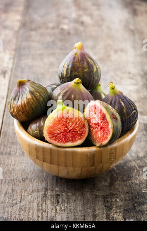 Fresh figs in a bowl on white wooden background, side view Stock Photo ...