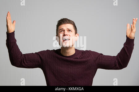 Portrait of shocked young man in bathrobe on pink background Stock ...