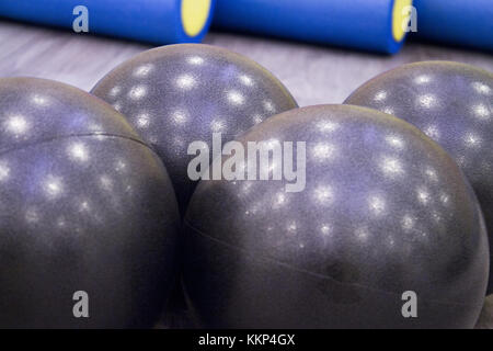 Medium size black balls for pilates exercises Stock Photo - Alamy