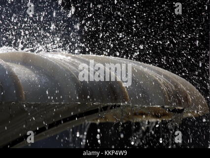 Fountain splashing in still lake Stock Photo - Alamy