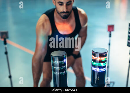 Sportsman with lights around to improve reaction time at gym. Athlete ...