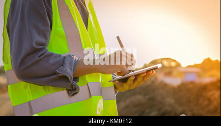 architect using tablet. engineer working on house blueprint of real ...