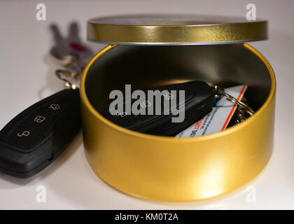 Car keys in a Tin - blocking the signal - Faraday cage Stock Photo - Alamy