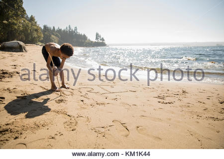 Boy writing in sand with stick, Grand Sand Dunes National Park Stock ...