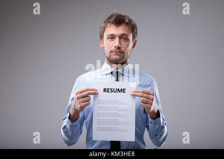 Potential male job applicant holding up his CV Stock Photo - Alamy