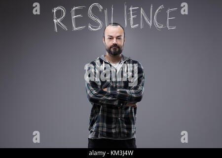 Attractive bearded man with the word Resilience Stock Photo - Alamy