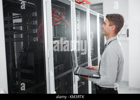 Man working in server room Stock Photo - Alamy