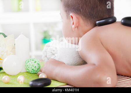 young boy relaxing in spa salon with spa stone Stock Photo - Alamy