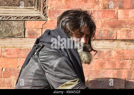 Homeless man in the UNESCO temples of Bhaktapur, Nepal Stock Photo - Alamy