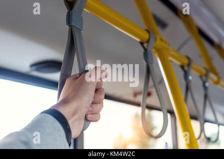 man holding bus handle Stock Photo - Alamy
