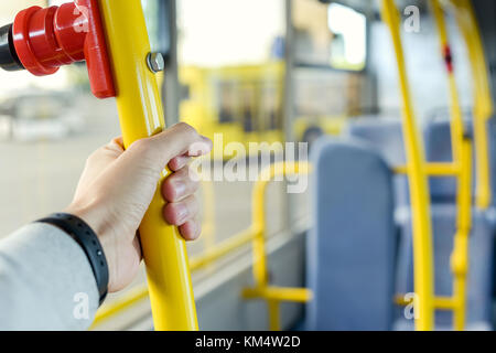 man holding bus handle Stock Photo - Alamy