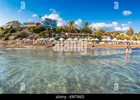 People relaxing on Coral Bay Beach, one of the most famous beaches in ...