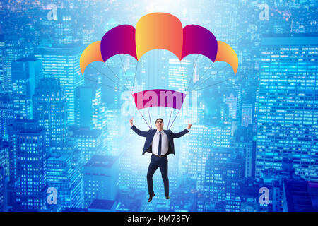 Young businessman falling on parachute in business concept Stock Photo ...