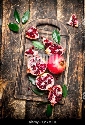 Fresh pomegranate on cutting board Stock Photo - Alamy