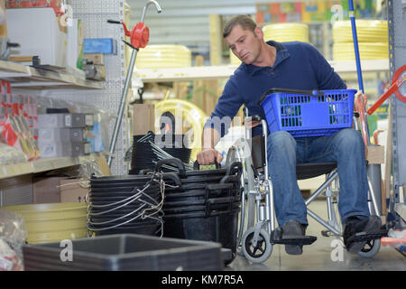 disabled man shopping in a hardware store Stock Photo - Alamy