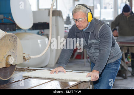 Machine cutting pvc profile. Production of PVC windows, a section of ...