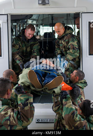 Airmen from the 446th Aeromedical Staging Squadron, carry a litter with ...
