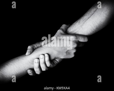 Man saving, rescuing and helping woman by holding or griping the ...