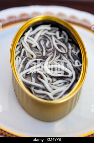 Canister of canned elvers on a elegant dish Stock Photo - Alamy