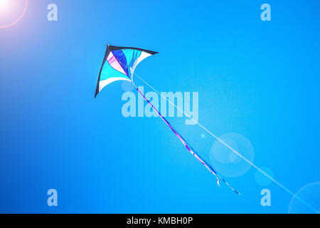 Triangle kite flying on a sunny day blue sky Stock Photo - Alamy