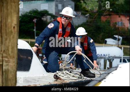T & T Salvage deploy boom in response to a sunken barge near the ...