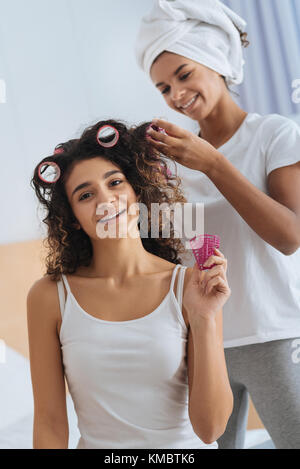 Girl getting sisters hair ready to put it into a ponytail Stock Photo ...