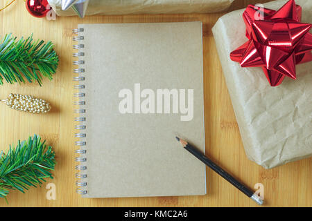 Brown gift box and empty notebook paper for Christmas decoration on ...