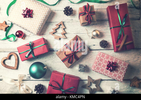 Christmas decorations and gift wrapping items on wooden background ...