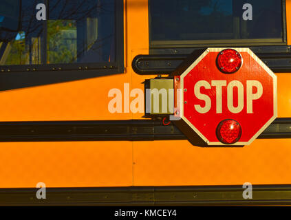 Stop: An illuminated swing out stop sign mounted on the side of a ...