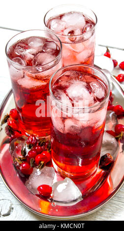 Wild rose cocktail . Fresh cocktail with ice on a tray . Free space for ...