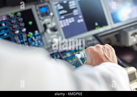 High angle view of pilot holding steering wheel in airplane cockpit ...