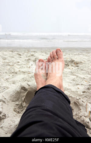 legs and feet without shoes on desk with white screen Stock Photo - Alamy