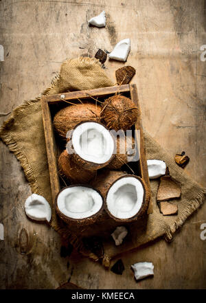 fresh coconuts on old wooden table Stock Photo - Alamy