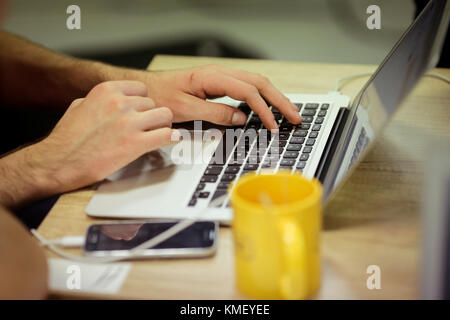 Man uses laptop for coding software Stock Photo - Alamy
