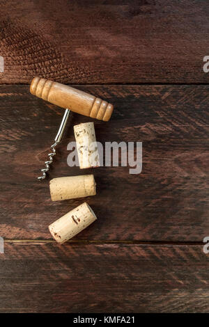 A photo of an old-fashioned corkscrew with corks, shot from above on a ...