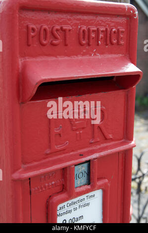 Closeup of a red mailbox and white paper hearts on a red background for ...