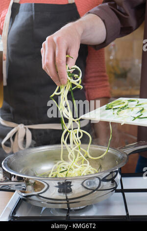 Mature Women is cooking a Italian Spaghetti Dinner in her home kitchen ...