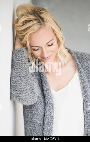 Studio shot of beautiful woman against gray background Stock Photo - Alamy