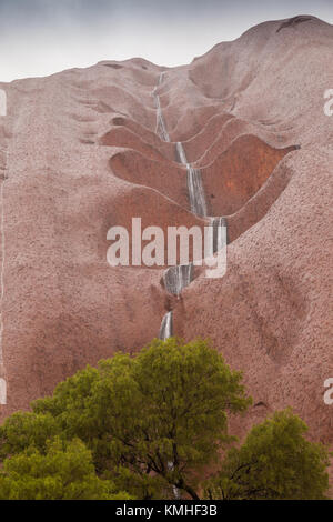 Ayers Rock in the rain - waterfalls on Uluru during a rare rainstorm in ...