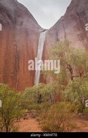 Ayers Rock in the rain - waterfalls on Uluru during a rare rainstorm in ...