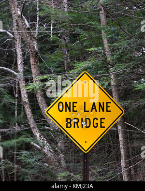 Yellow warning sign warning of a one Lane Bridge ahead Stock Photo - Alamy