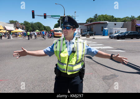 Traffic police officer with safety vest and white gloves regulating ...