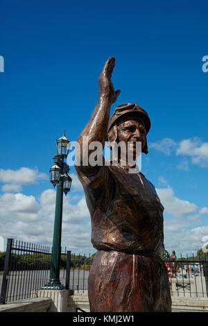 Bronze statue of Juan Manuel Fangio standing alongside his grand prix ...